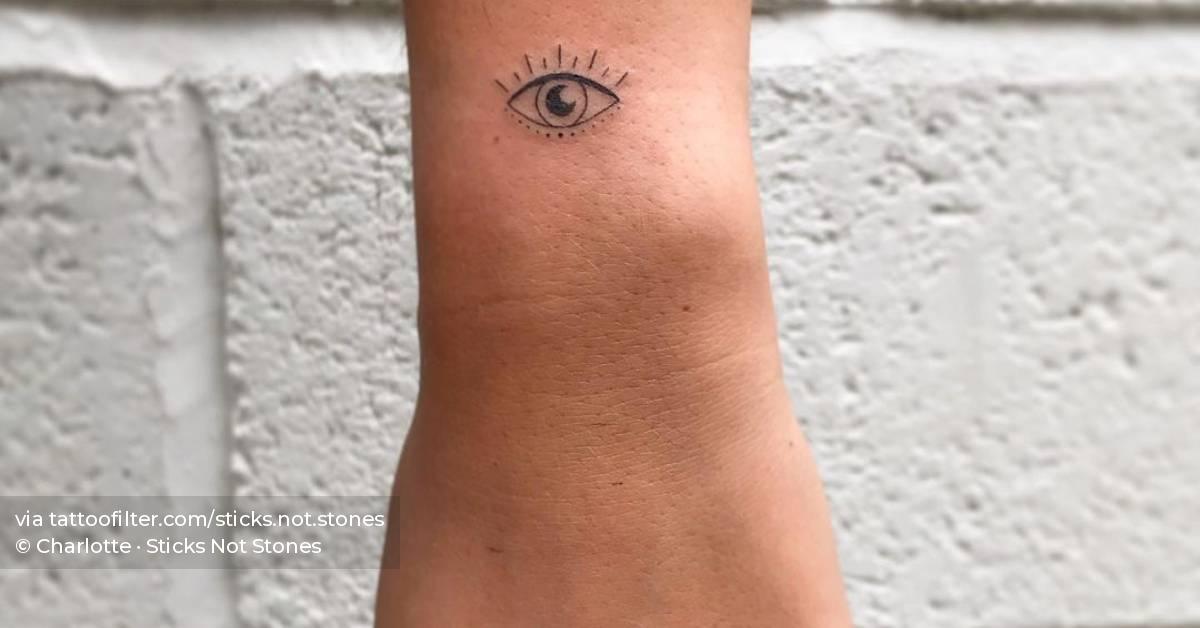 Hand poked evil eye tattoo on the wrist.