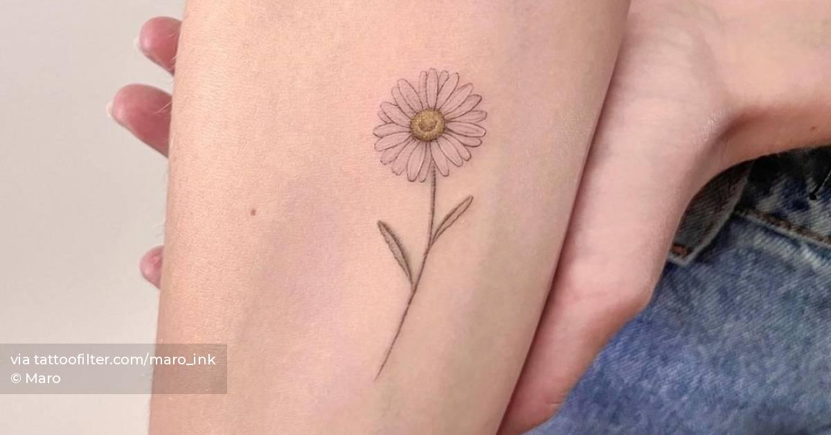 Micro-realistic daisy flower tattoo on the inner