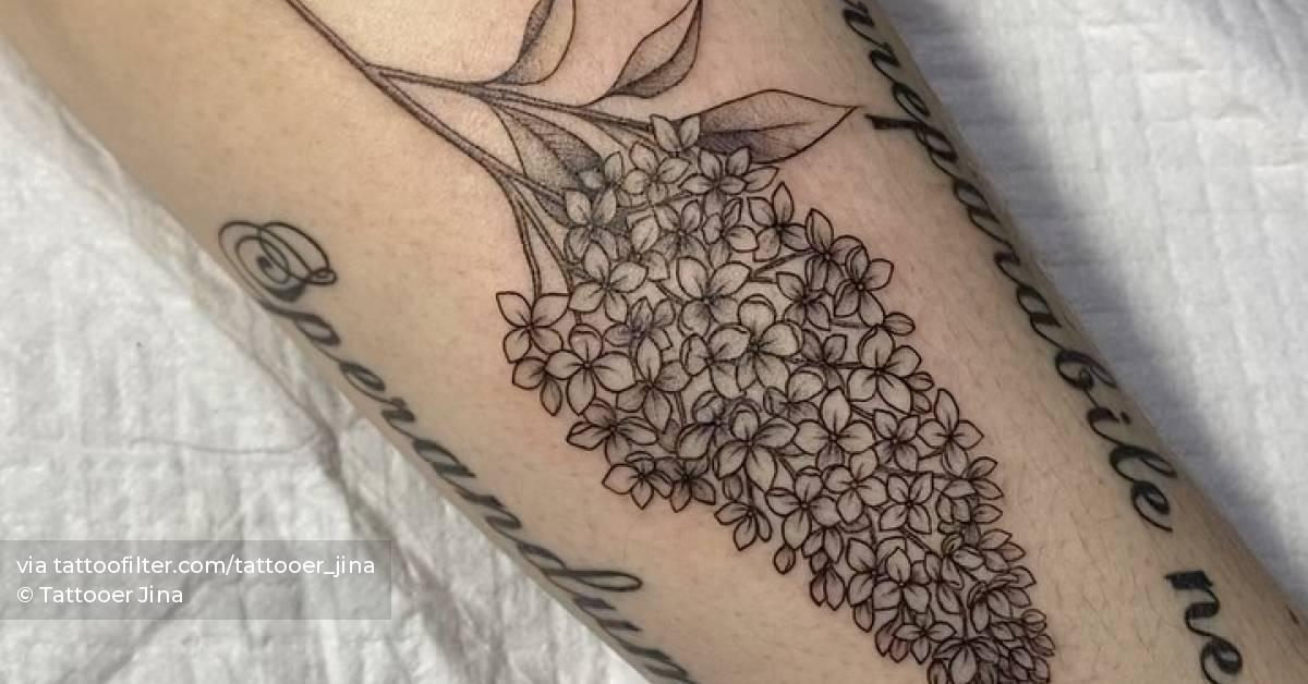 Fine line lilacs tattoo on the forearm.