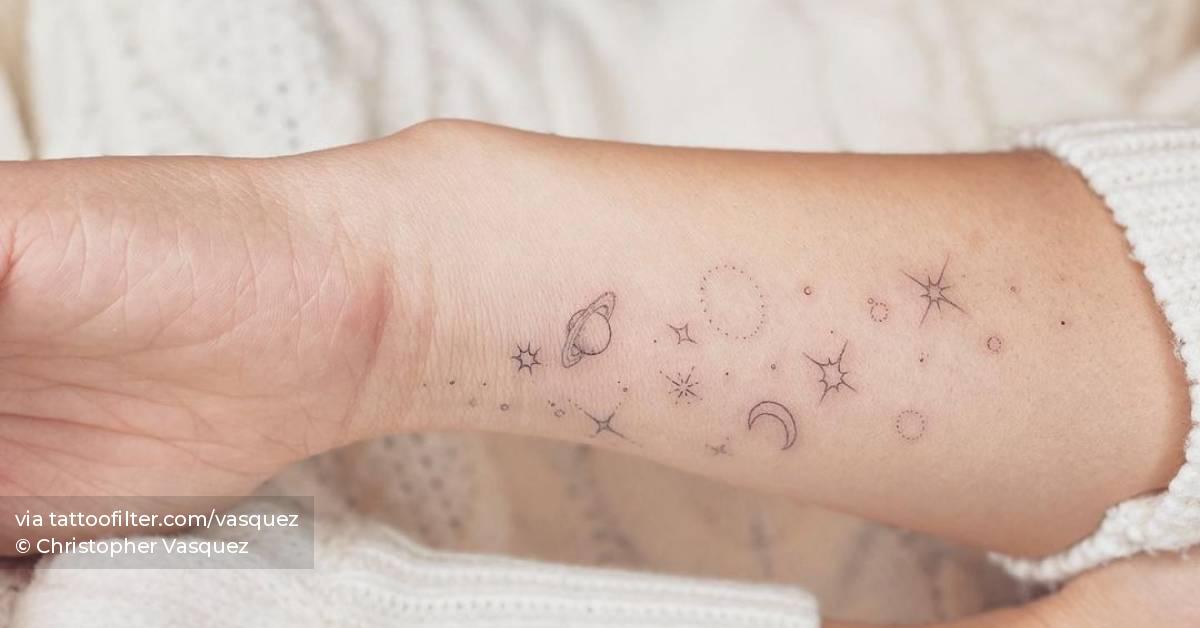 Fine line galaxy tattoo on the wrist.