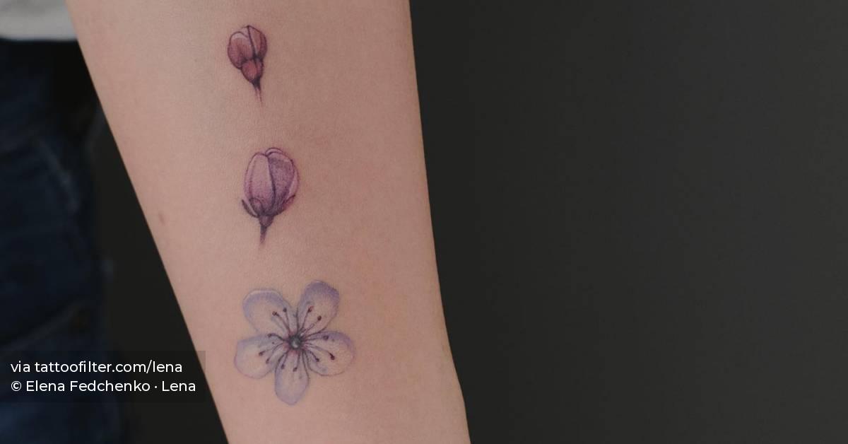 Watercolor style blooming flower tattoo located on the