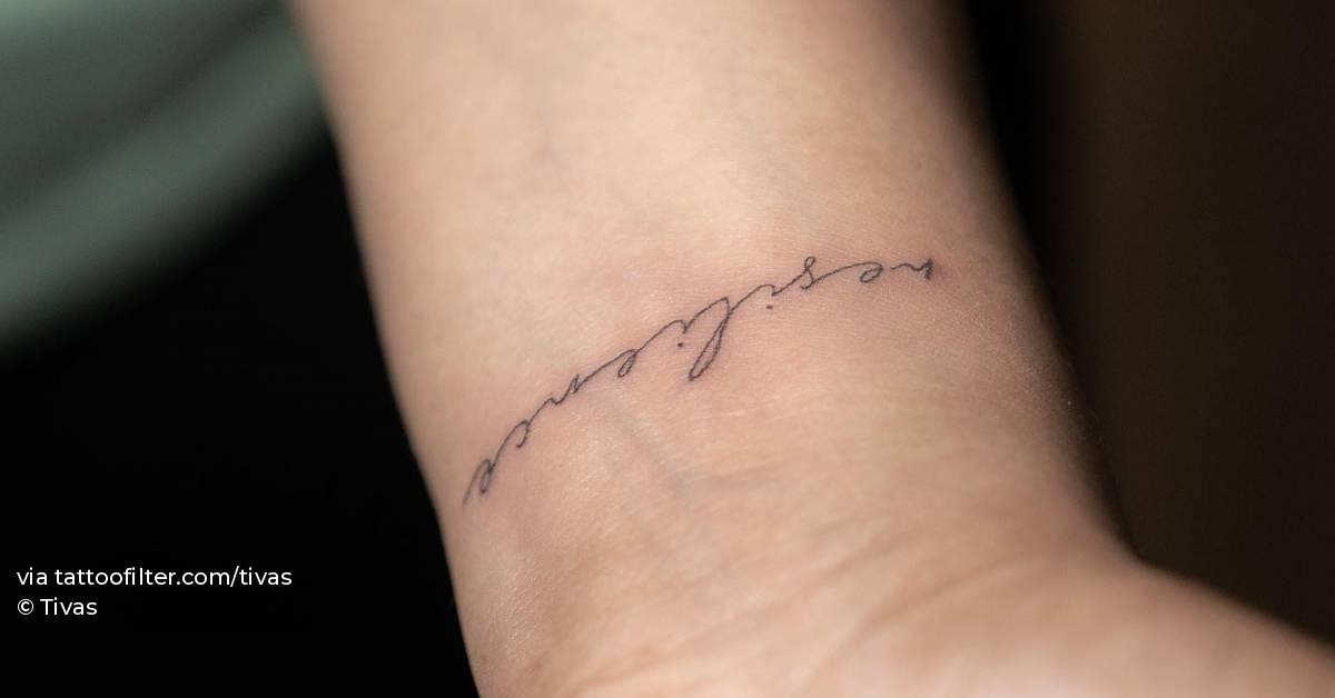 Tattoo of the word "resilience" handwritten on the