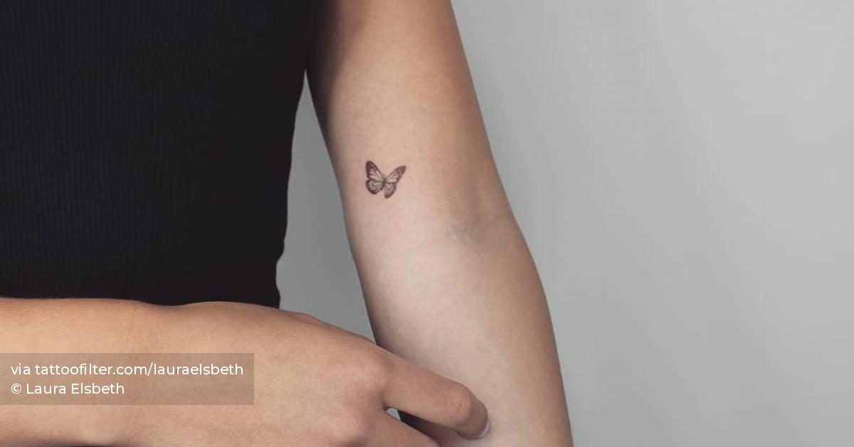 Fine line butterfly tattoo placed on the inner forearm.