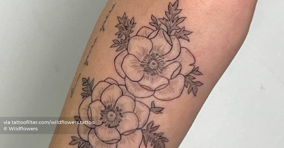 Healed anemone flowers tattooed on the inner forearm.