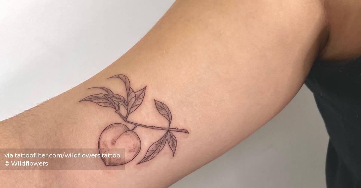 Peach tattoo located on the inner arm.
