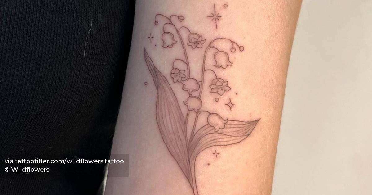 Fine line style lily of the valley tattoo located on