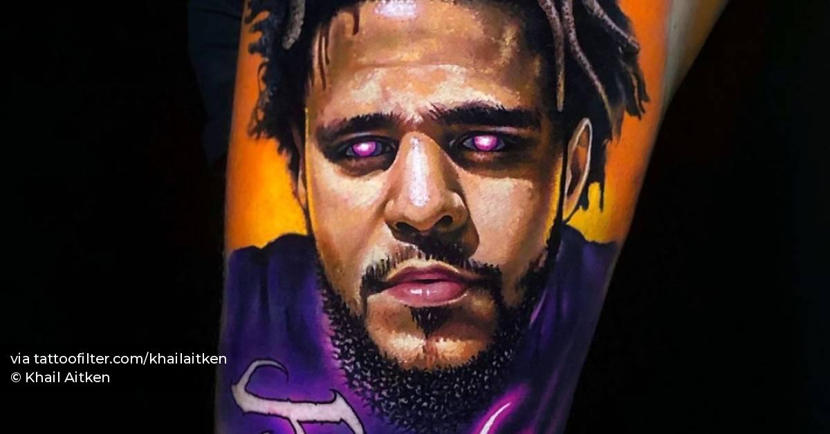 Realistic J. Cole portrait tattoo located on the thigh.
