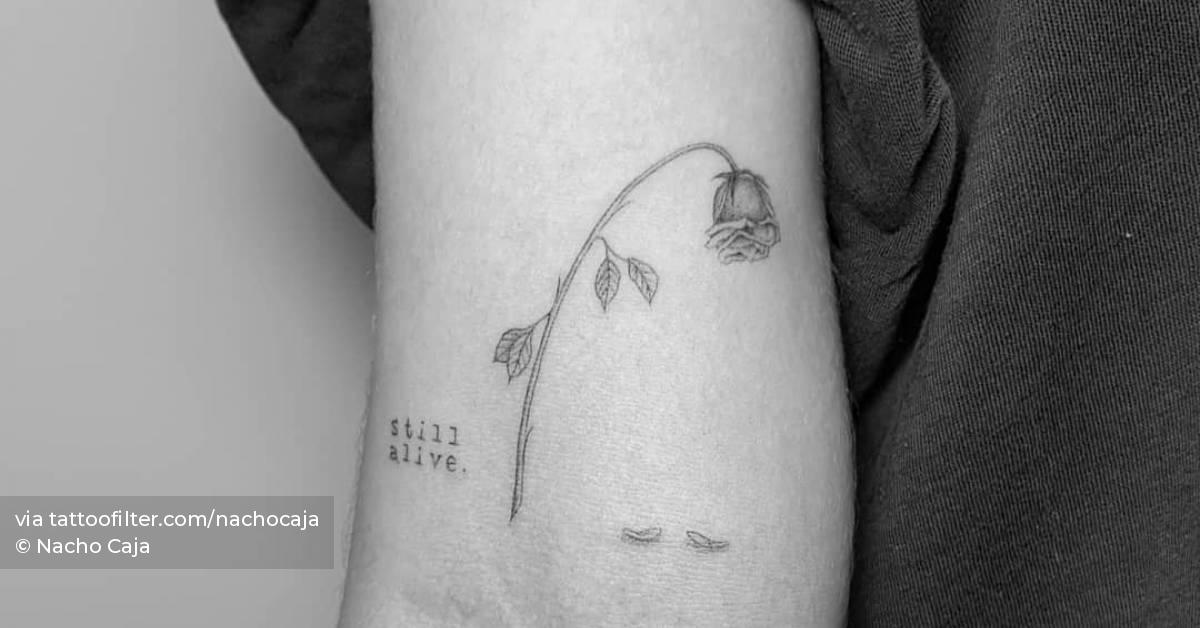Micro-realist rose tattoo on bicep