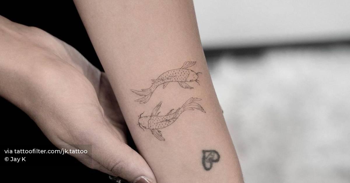 Single needle Koi fish tattoo on the inner forearm.