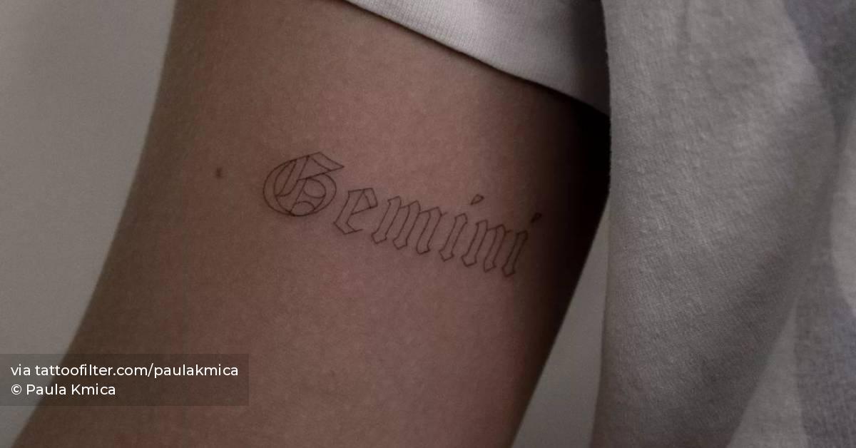 "Gemini" lettering tattoo located on the inner arm.