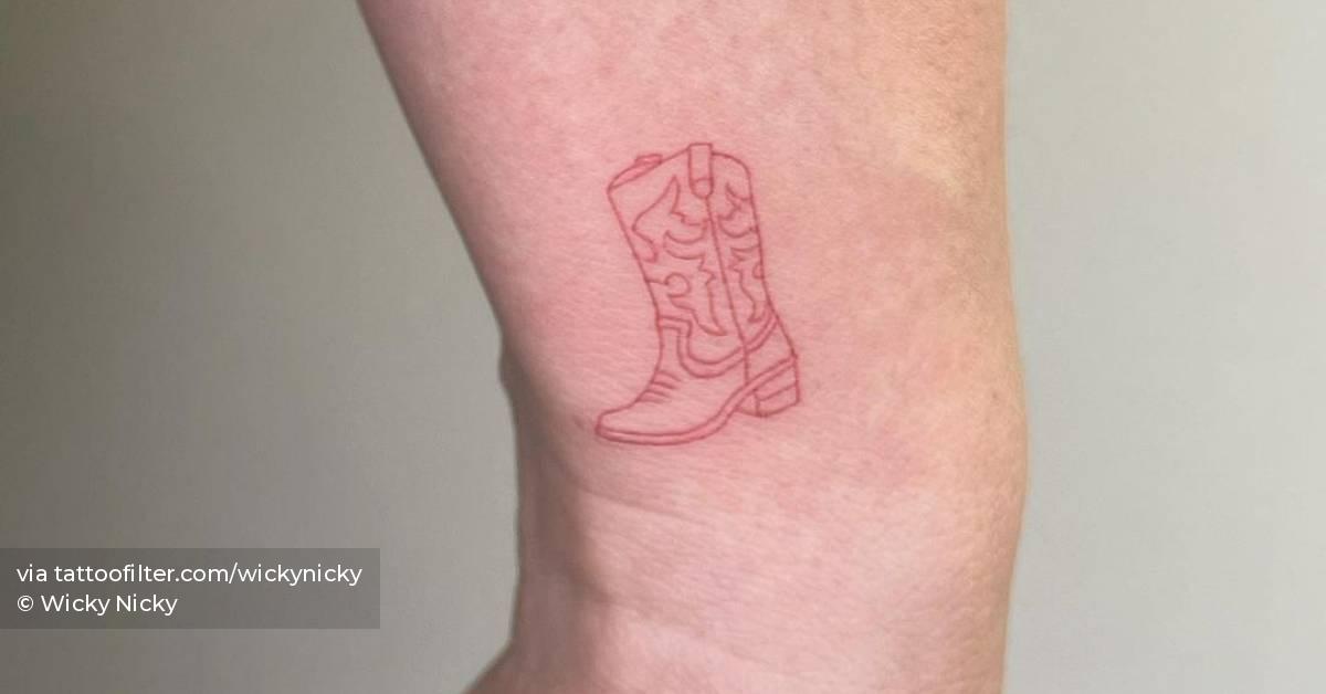 Fine line style red cowboy boot tattooed on the wrist.