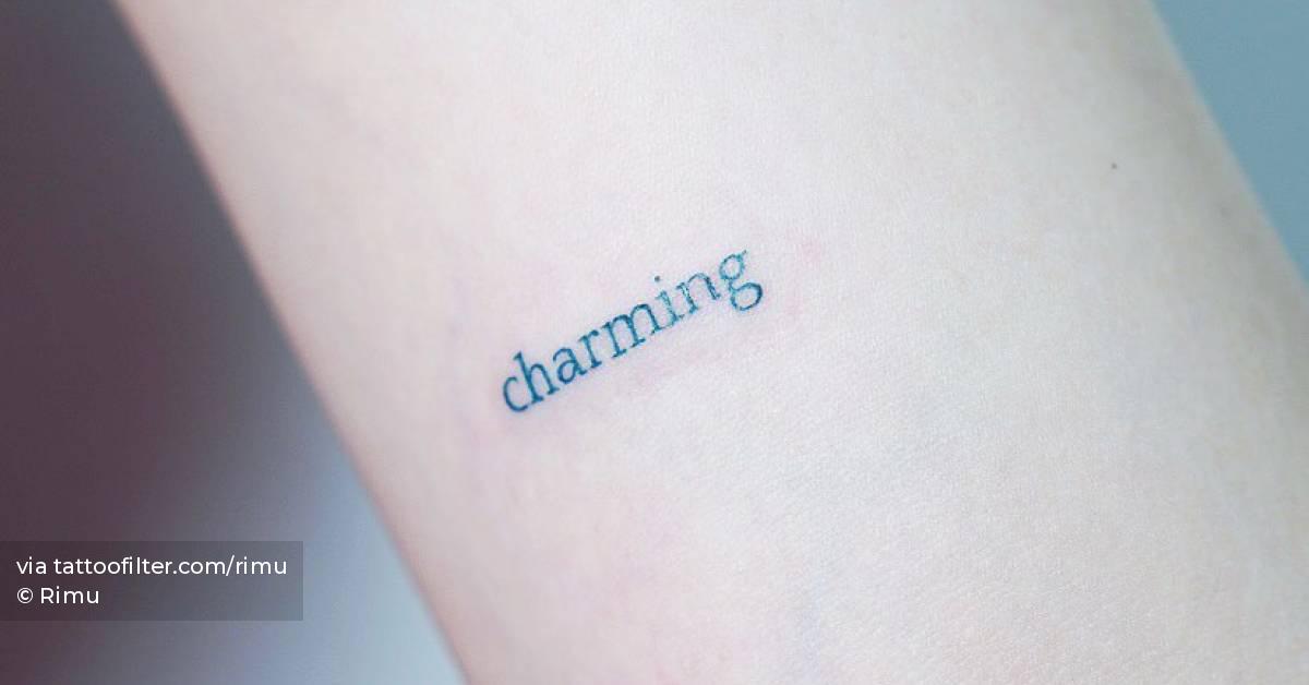 "Charming" lettering tattoo in blue ink located on the