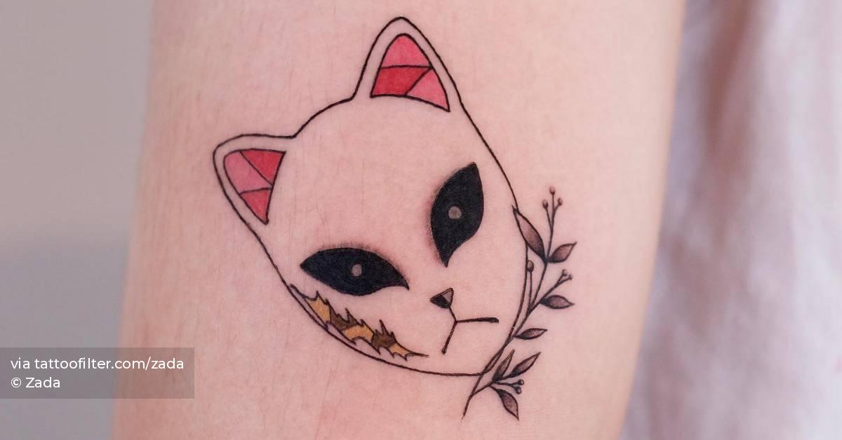 'Demon Slayer' mask tattooed on the upper arm.