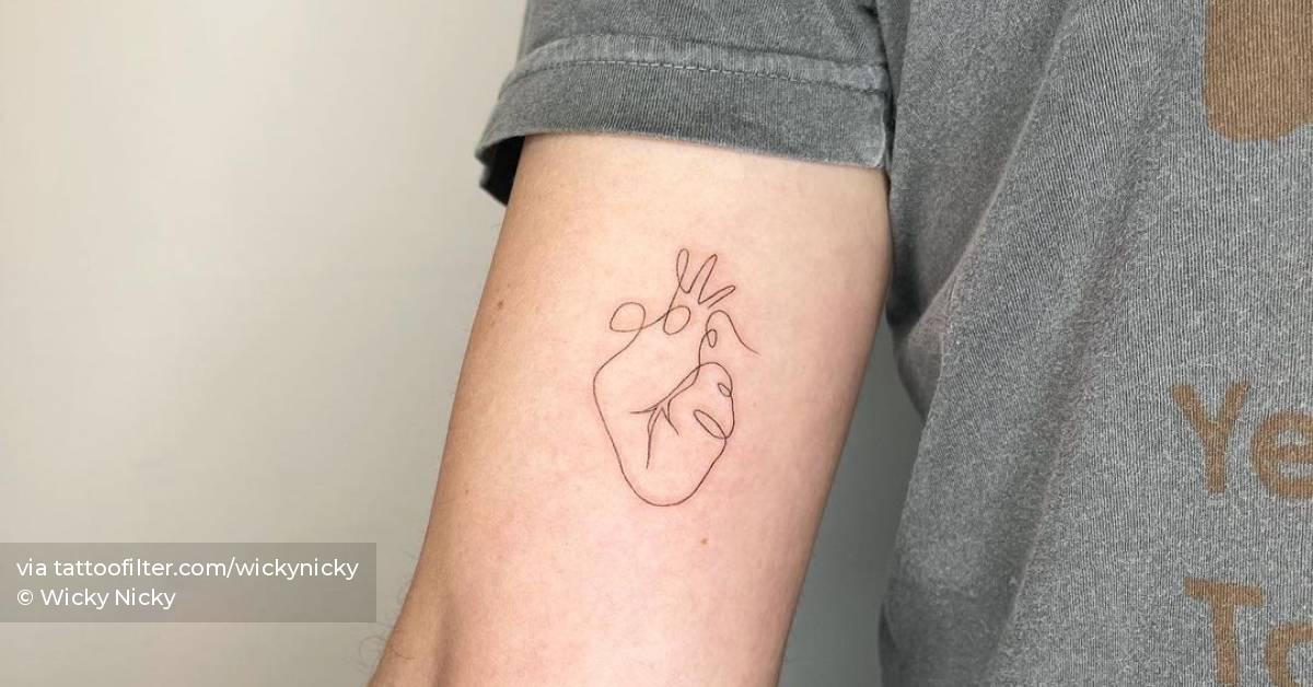 Continuous line anatomical heart tattoo located on the