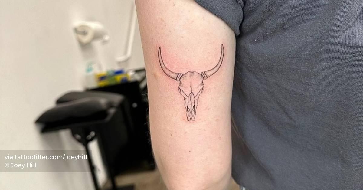 Fine line bull skull tattoo located on the tricep.