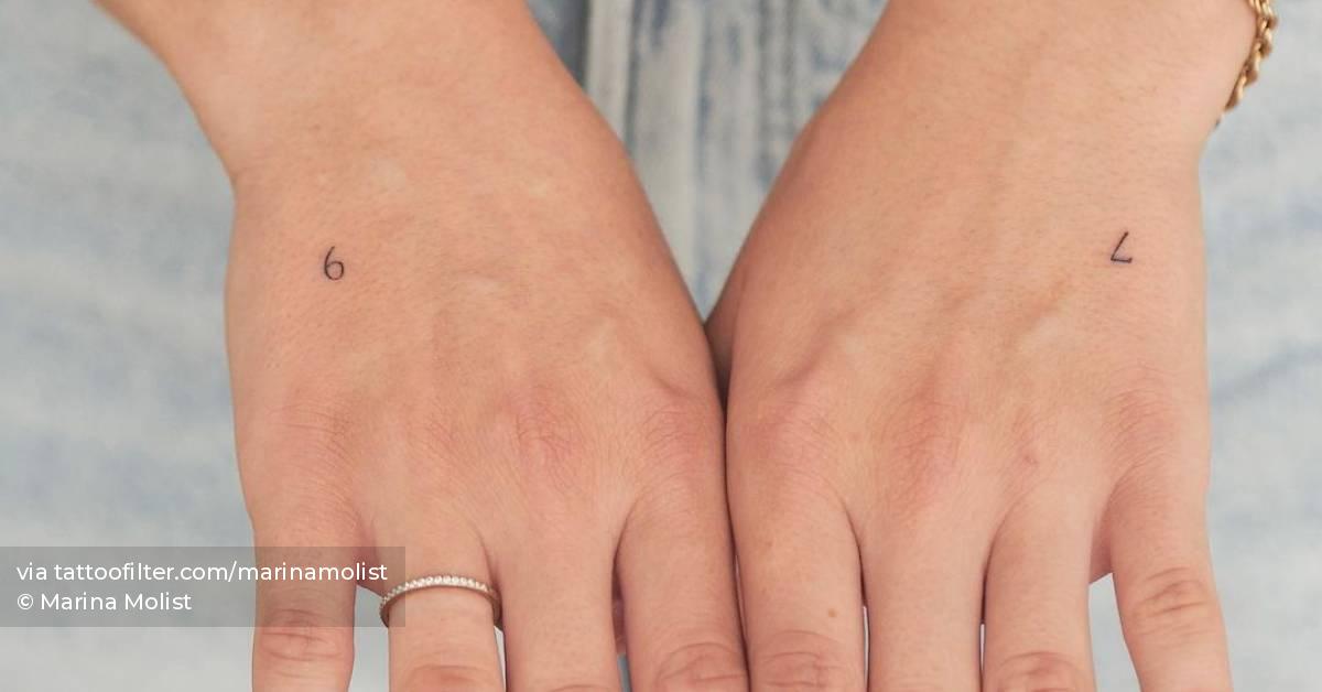 Individual matching numbers tattooed on the hands.