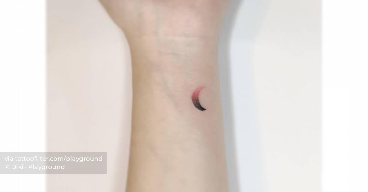 Minimalistic spectrum crescent moon tattoo located on
