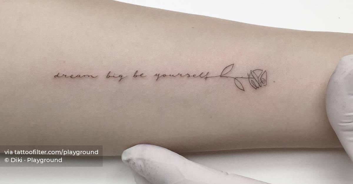 "Dream big be yourself" lettering tattoo located on the