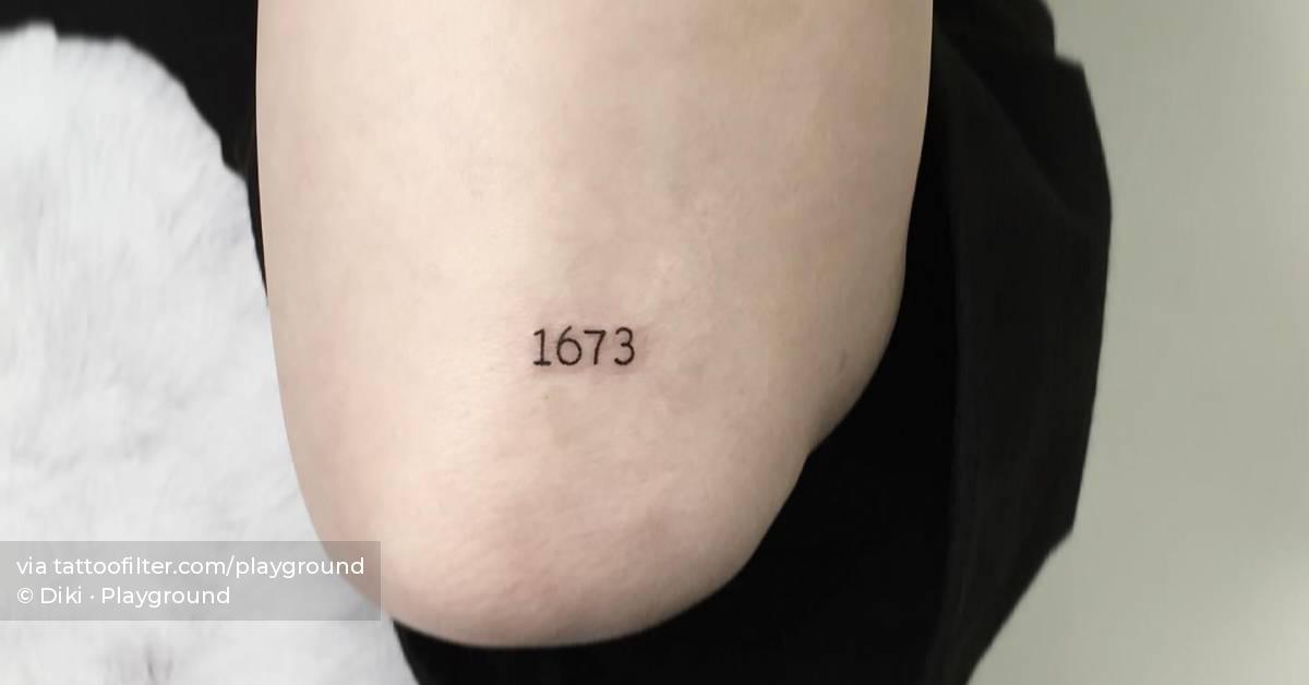 Tattoo of the number "1673" located on the elbow.
