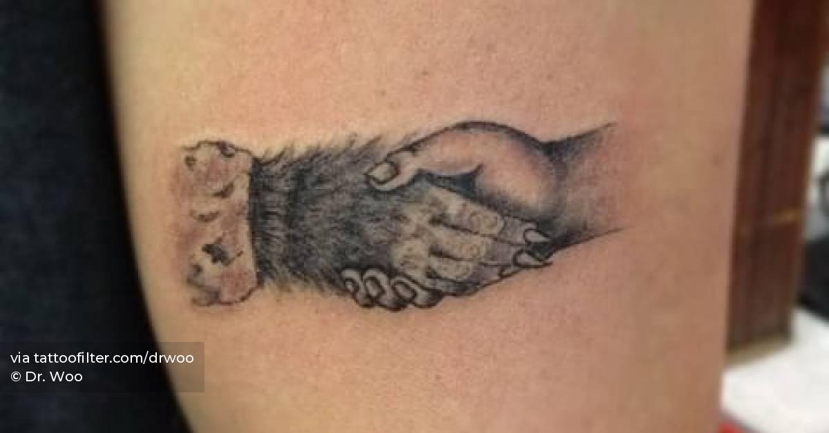 Handshake tattoo located on the upper arm.