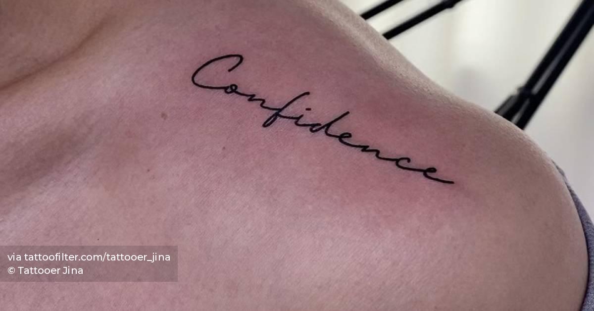 "Confidence" lettering tattoo on the top of shoulder