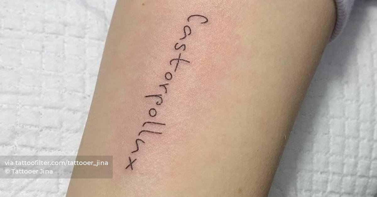 "Castorpollux" lettering tattoo on the inner forearm
