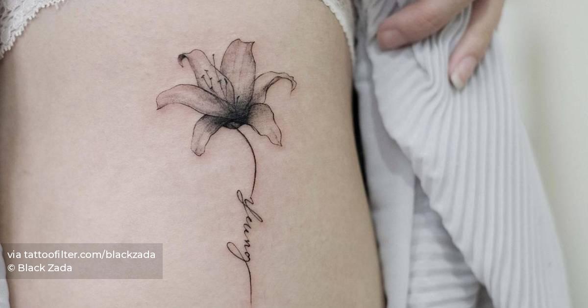 Fine line lily and "Yeung" tattoo on the hip.