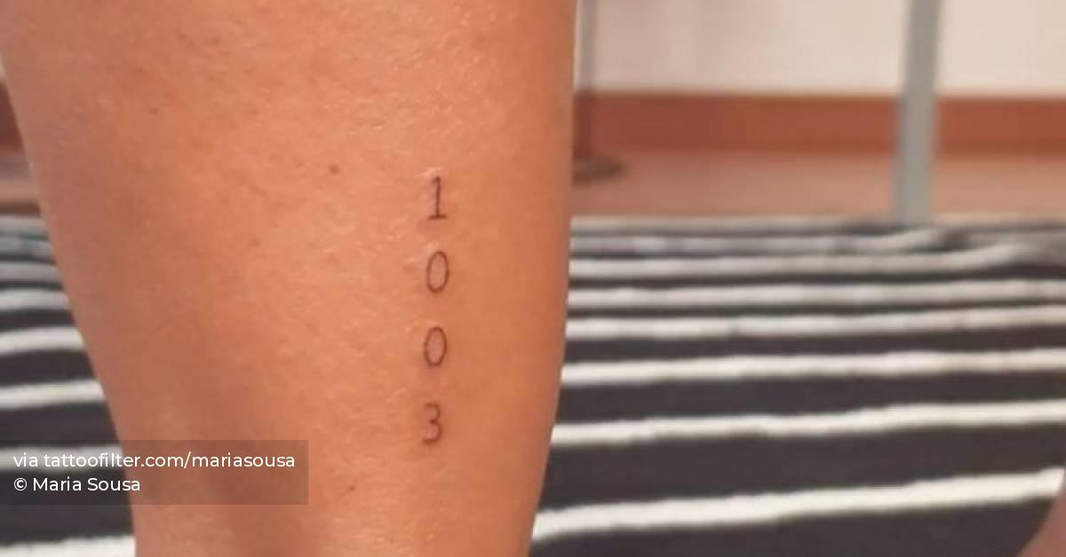 Number "1003" tattooed on the achilles.