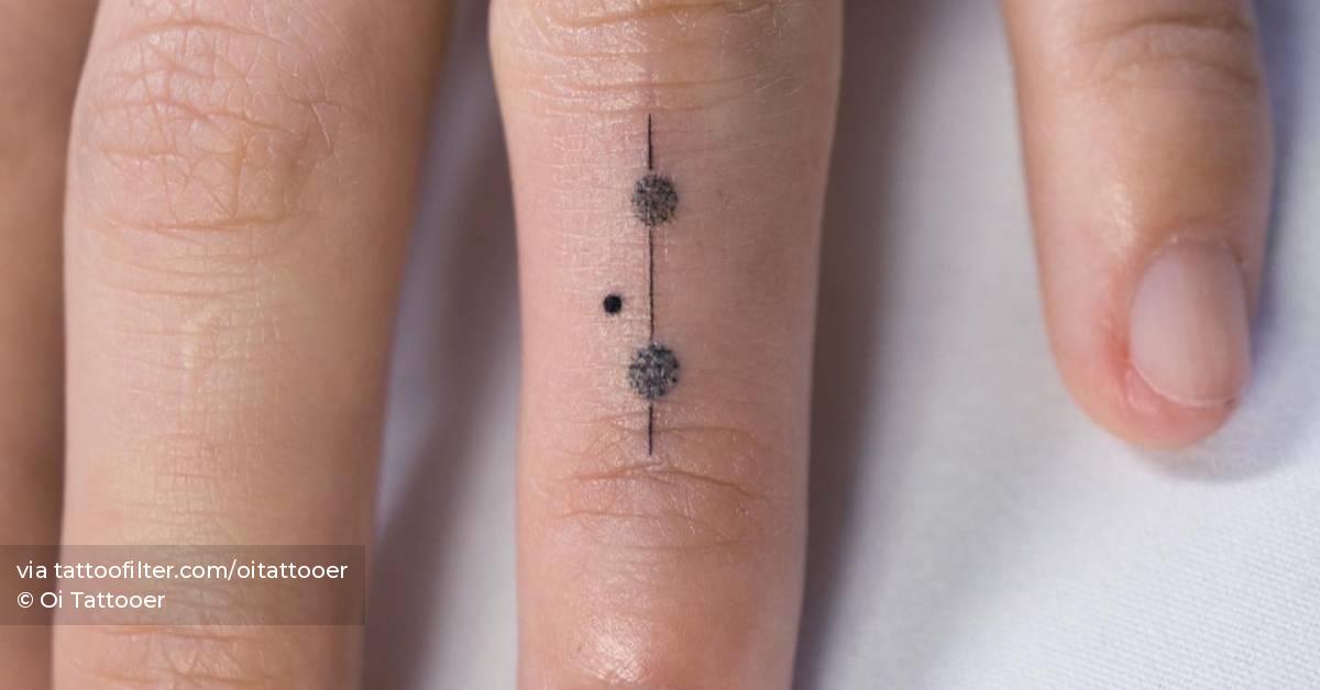 Dots and line tattoo located on the finger,