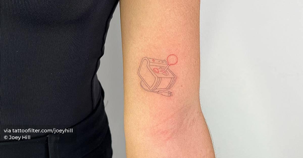 Video game controller tattooed on the inner arm, fine