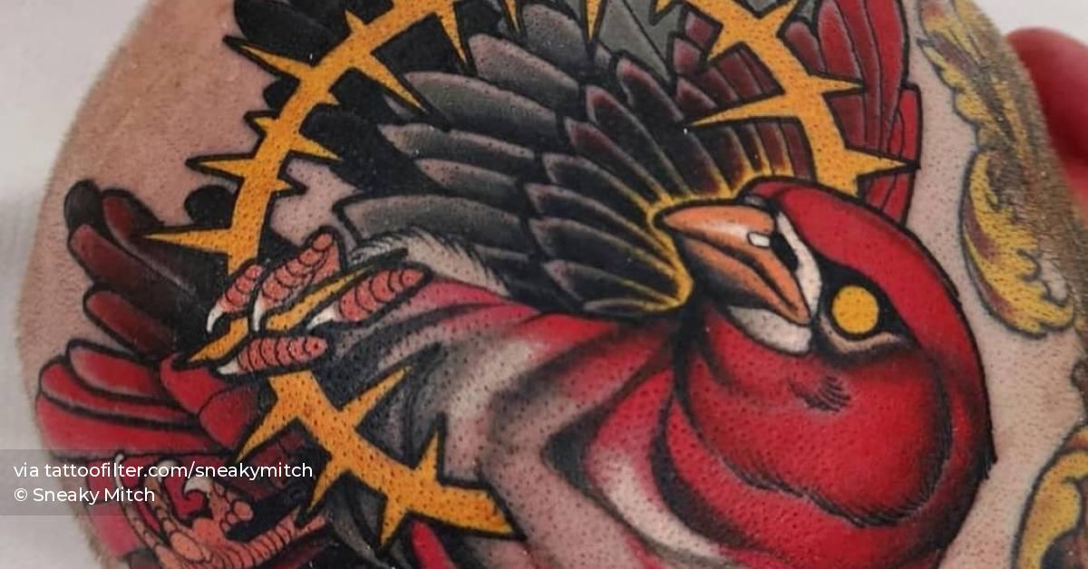 Neotraditional style cardinal tattoo done on the head.