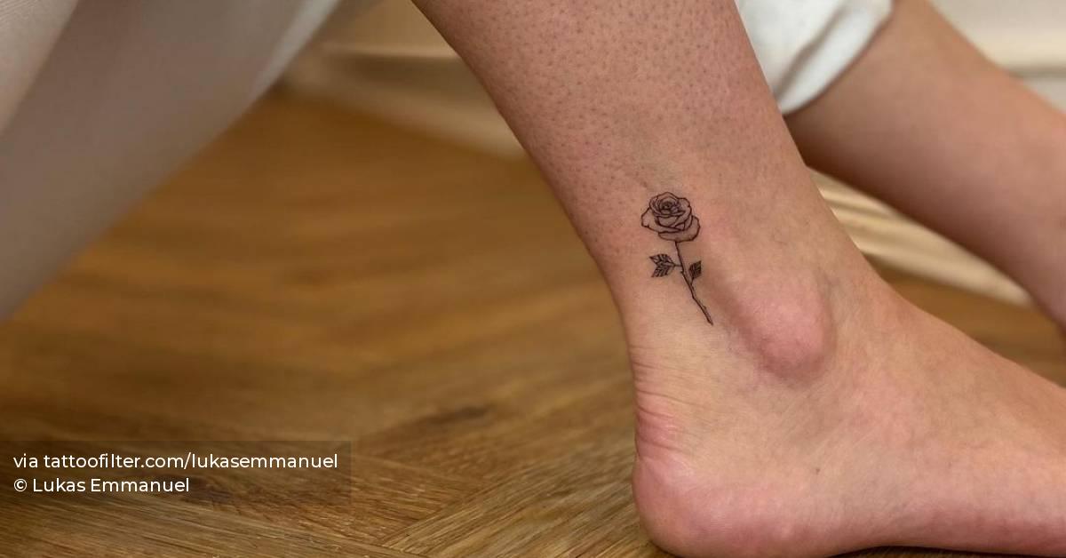 Rose tattoo located on the ankle, illustrative style.