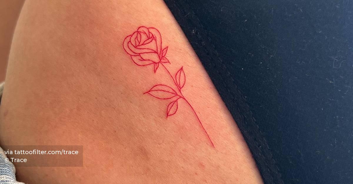 Fine line red rose tattoo located on the pelvis.