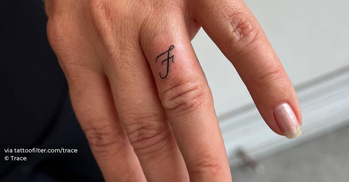 Tattoo of the letter "F" located on the finger.
