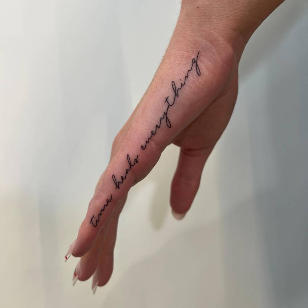  Time Heals Everything Lettering Tattoo Located On The