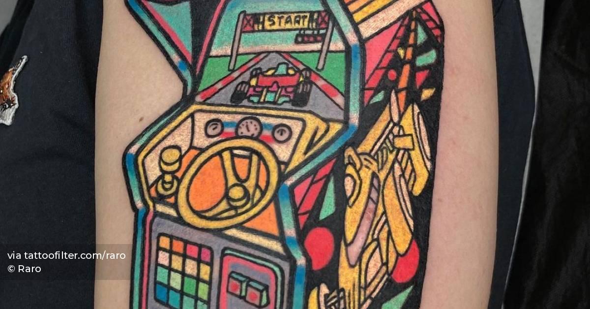 Pole Position arcade cabinet tattooed on the upper arm.