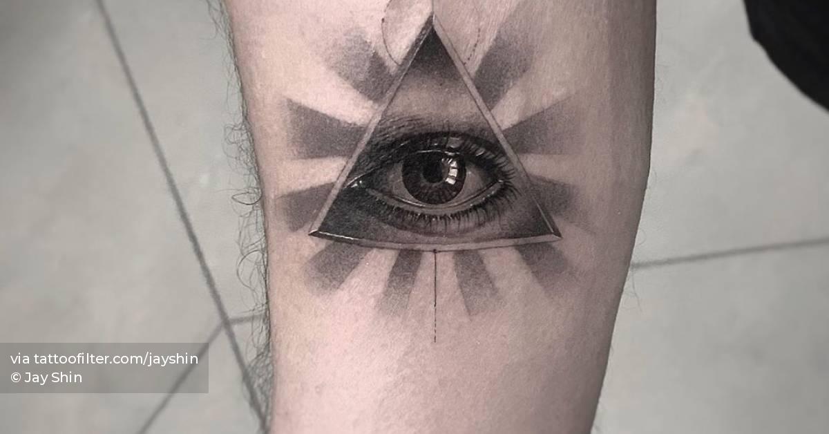 All-seeing eye tattoo on the inner forearm.