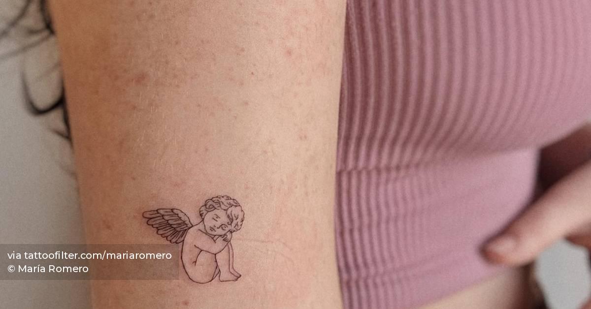 Fine line cherub tattoo done on the upper arm.