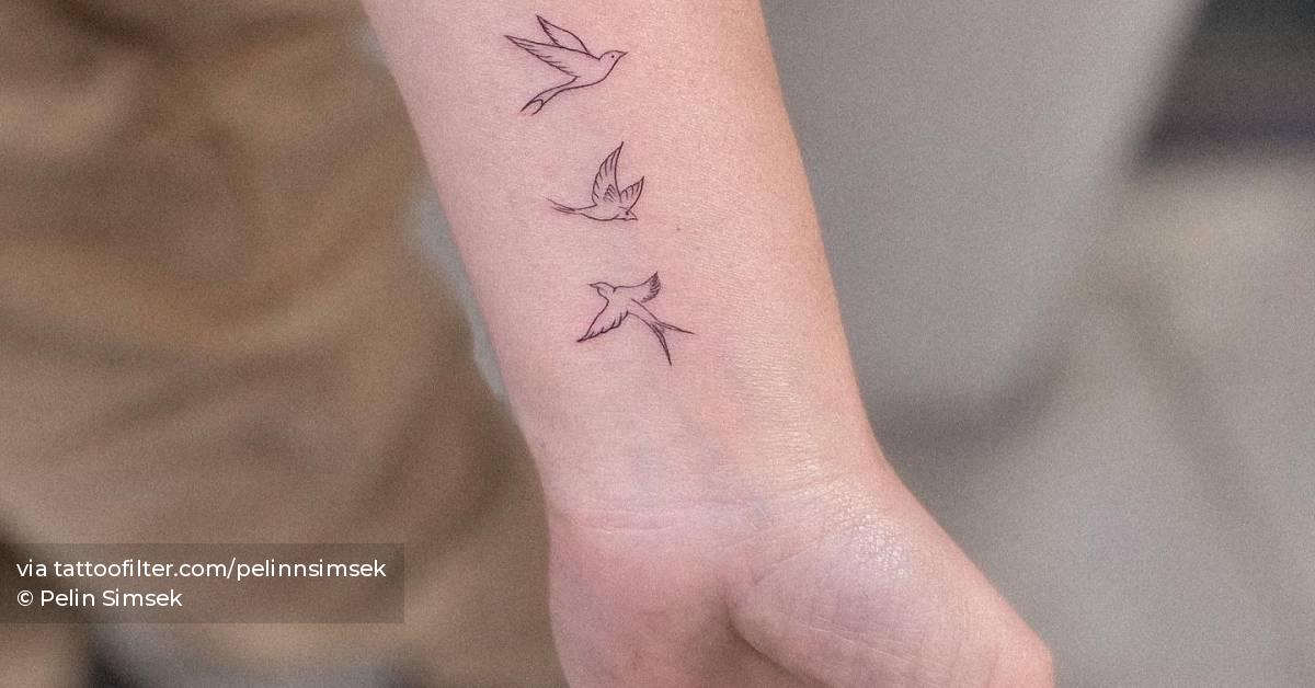Fine line style flying birds tattoo located on the