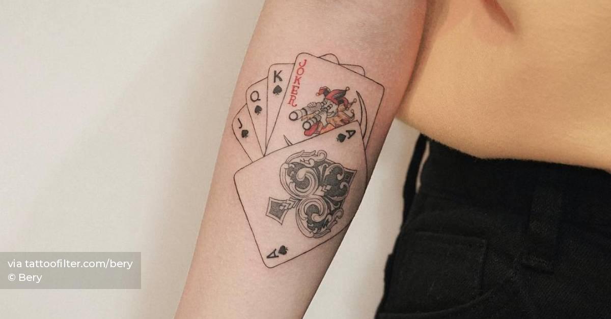 Playing cards tattoo on the inner forearm