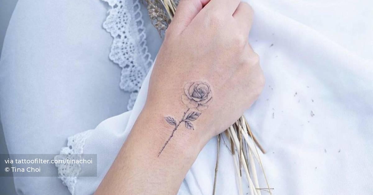 Fine line rose tattoo on the wrist.
