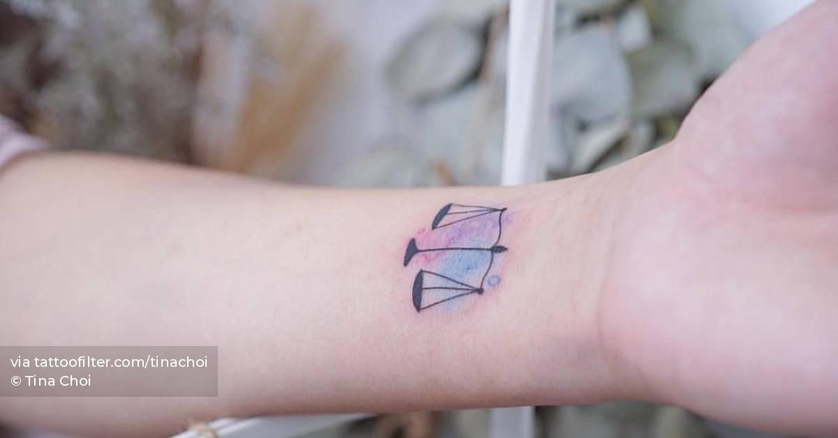 Watercolor scale tattoo on the wrist.