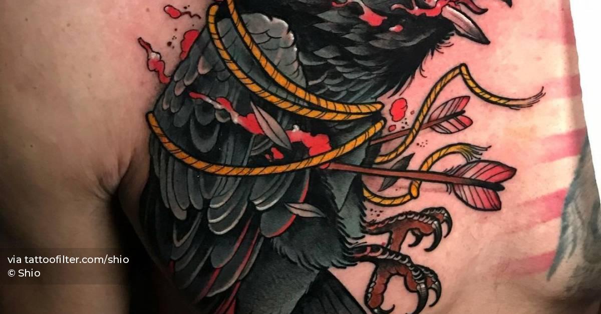 Neotraditional raven tattoo on the chest.
