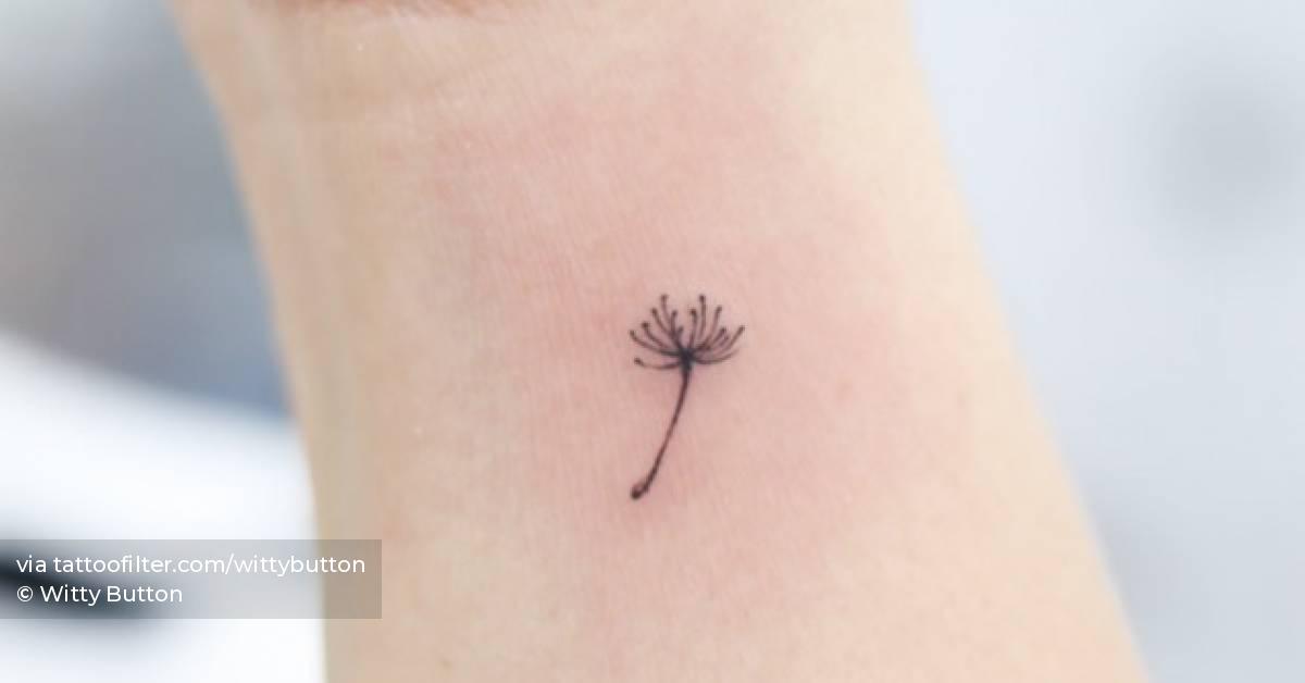 Minimalistic style dandelion seed tattoo located on the