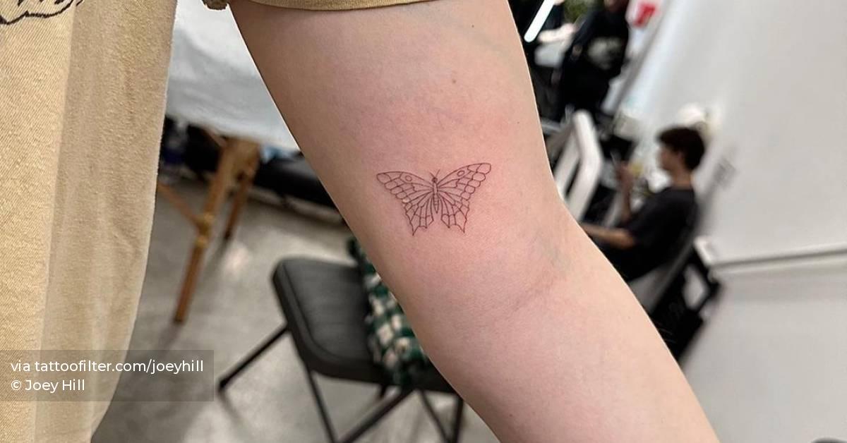 Tattoo of a fine line butterfly located on the inner