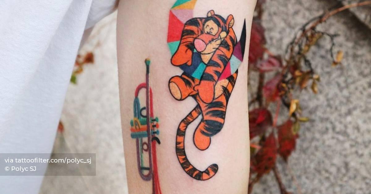 Healed trumpet and fresh Tigger tattoos.
