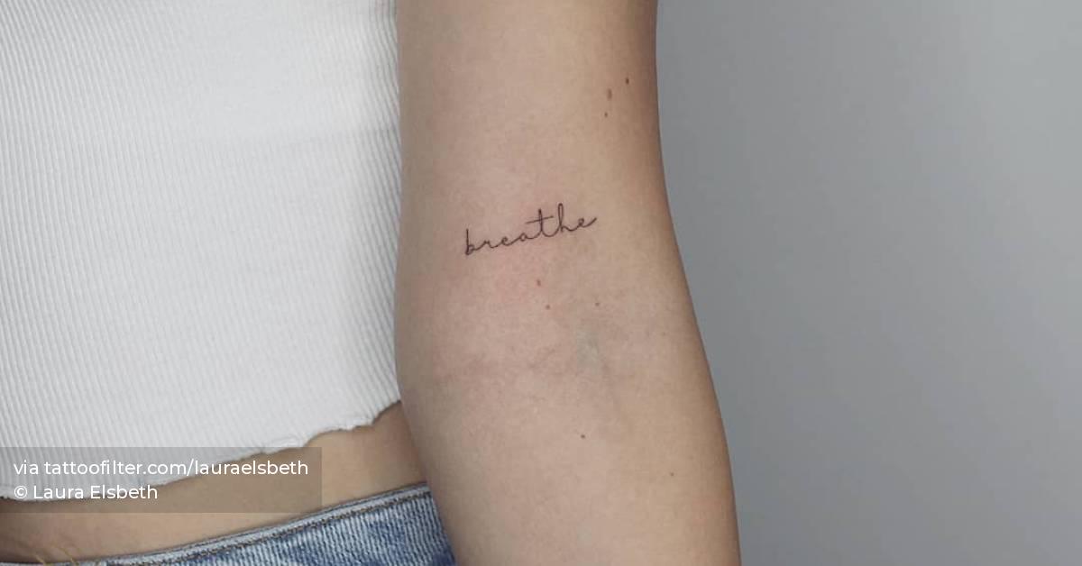 Tattoo of the word "breathe" located on the bicep.