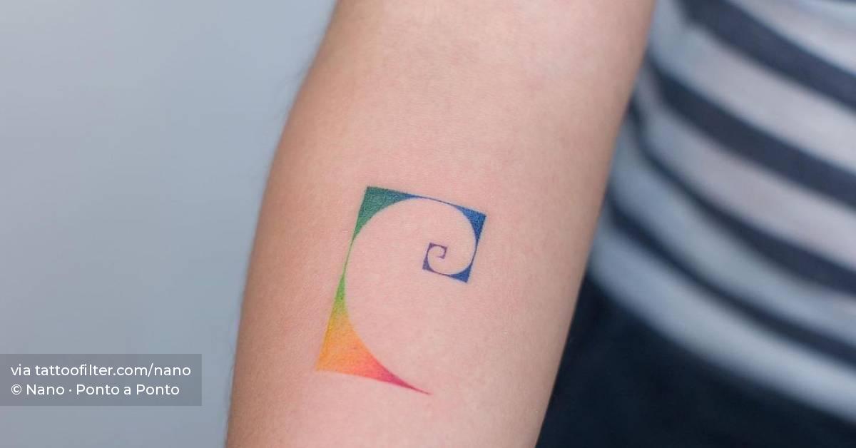 Hand poked golden spiral tattoo located on the inner