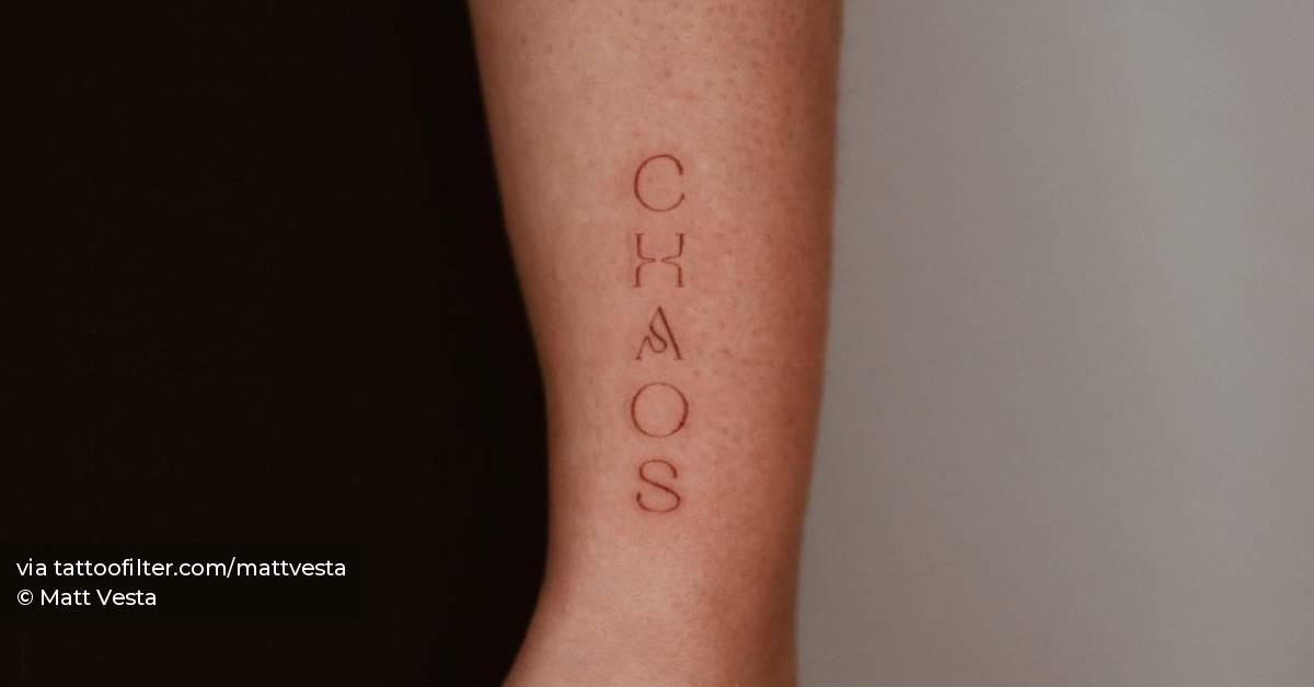 Tattoo of the word "chaos" located on the wrist.