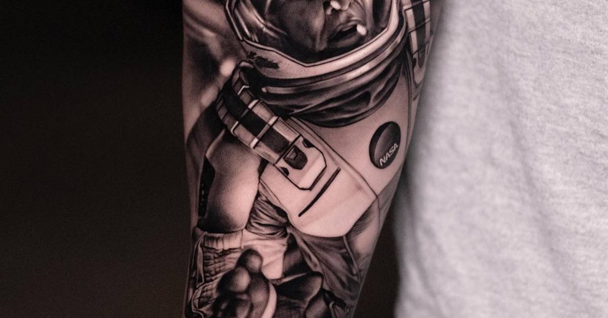 Black and grey 'Interstellar' tattoo located on the